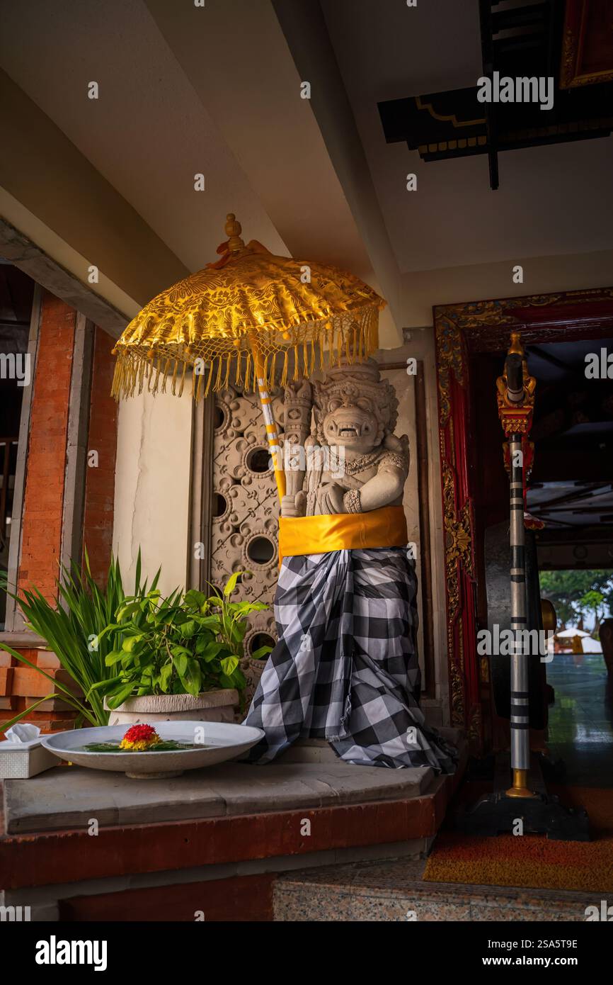 Bali, Indonesia: Statue in a Balinese temple adorned with ceremonial ...