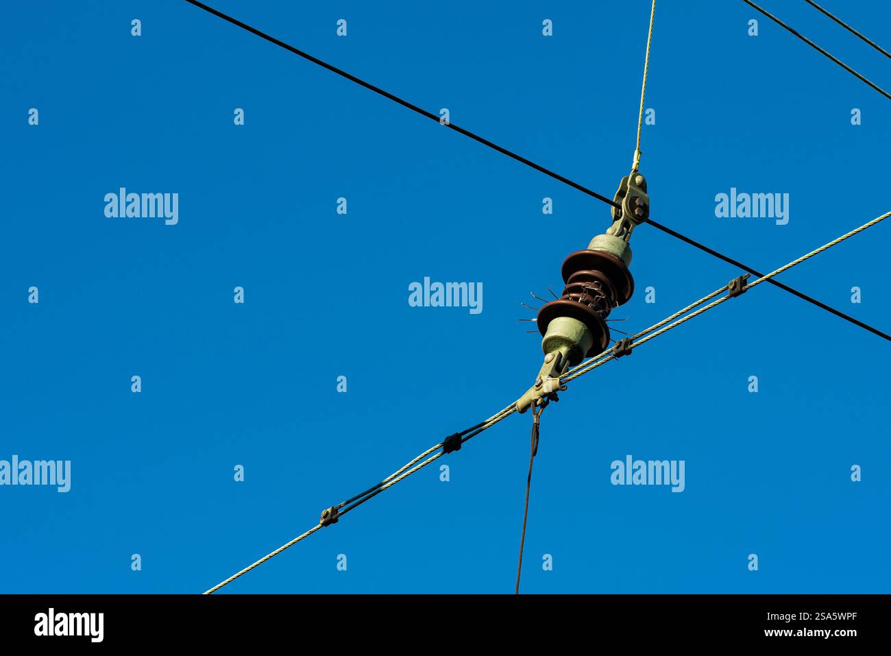 A close-up view of electrical power lines featuring a connector against ...