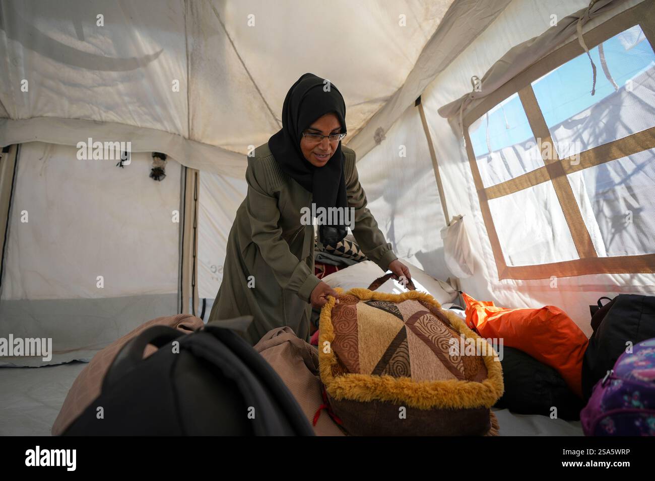 Majida Abu Jarad packs belongings as she prepares to go back to the ...