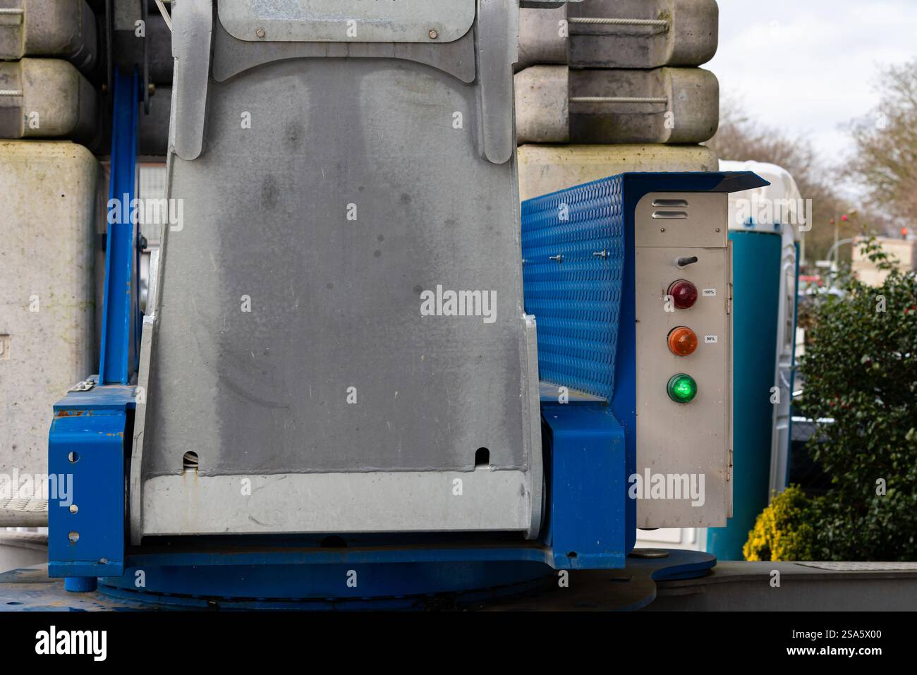A large blue construction machine stands ready for operation in an ...