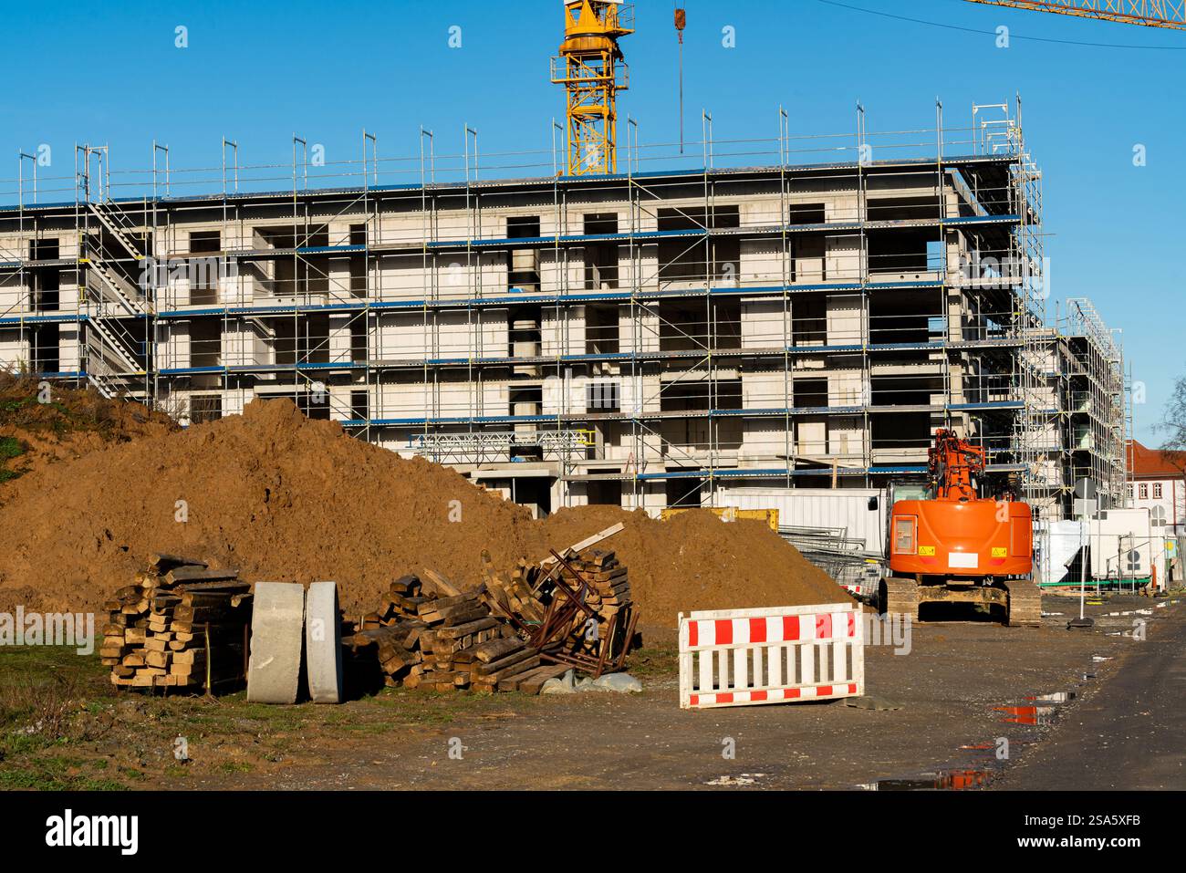 A busy construction site featuring earth moving equipment and a large ...