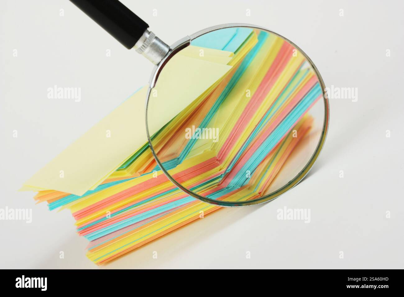 Magnifier enlarges the stack of sheets of paper Stock Photo - Alamy