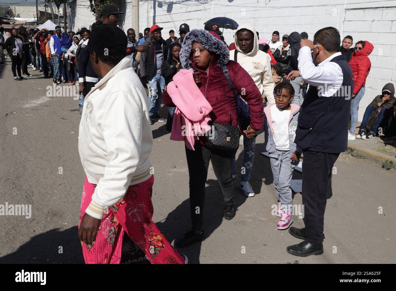 Haitian, Cuban and Venezuelan migrants wait outside the Mexican ...