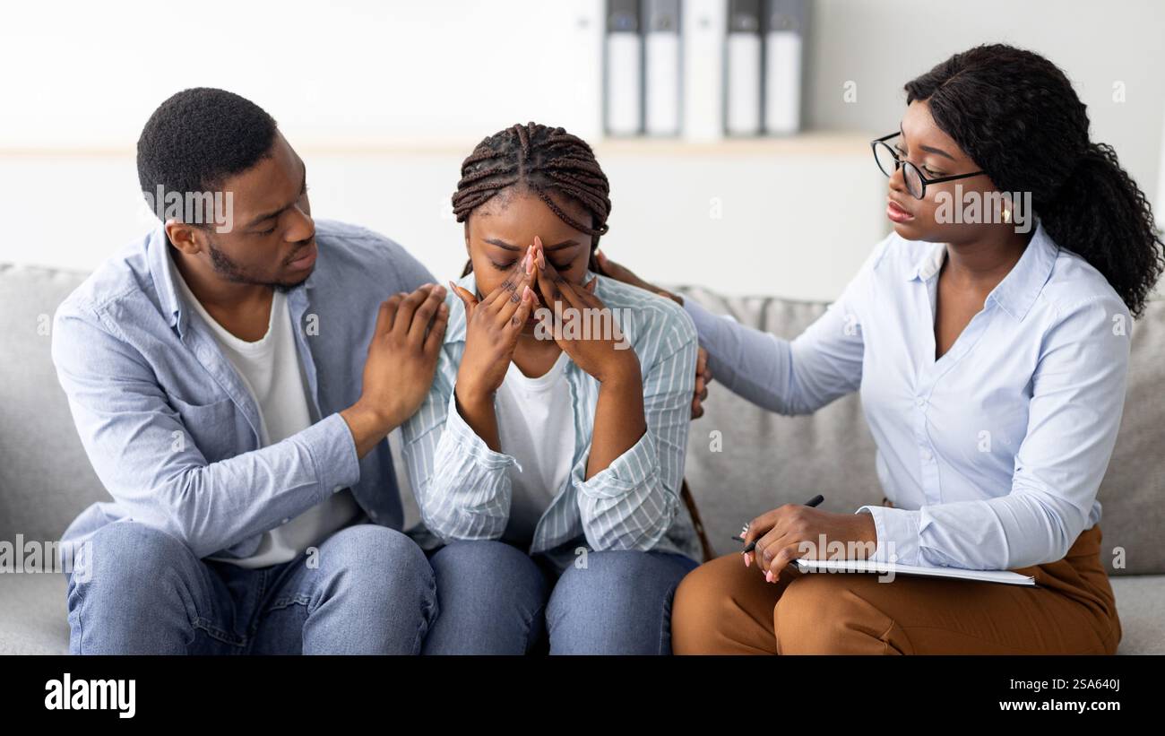 Young black woman crying at therapist's office, affectionate husband ...