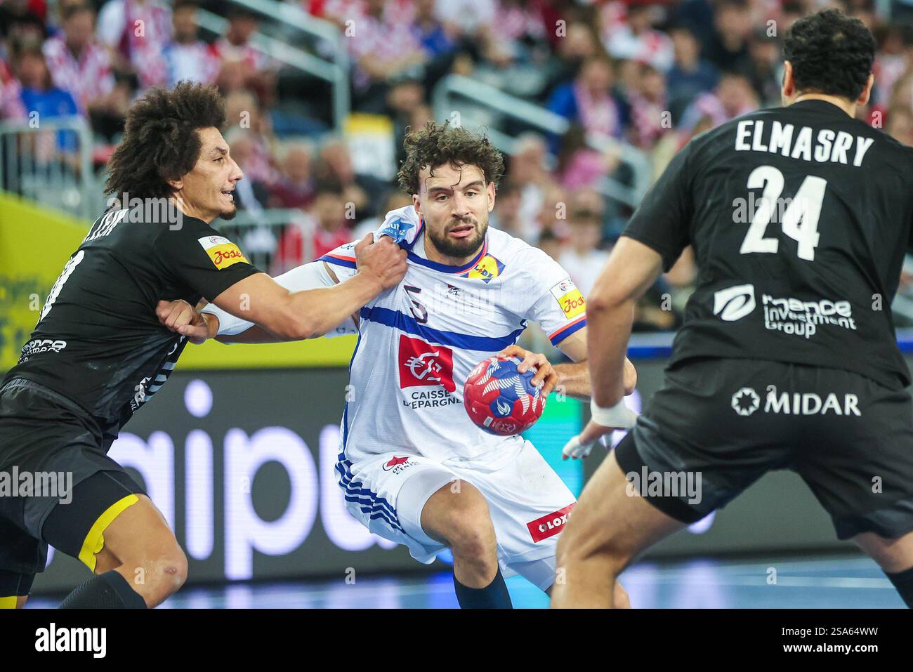 Nedim Remili of France is challenged by Ali Zein and Ibrahim Elmasry of ...