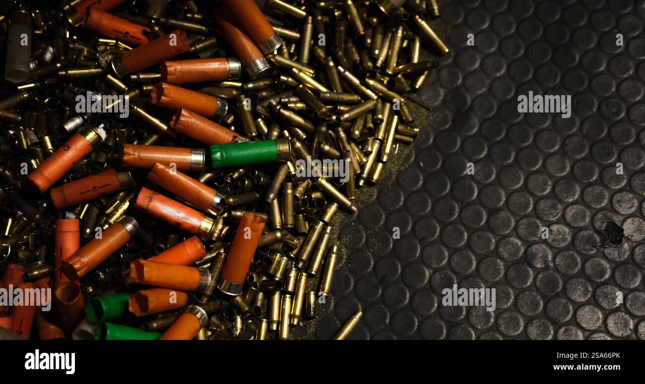 Spent brass casings of various calibers mixed gunpowder black rubber ...