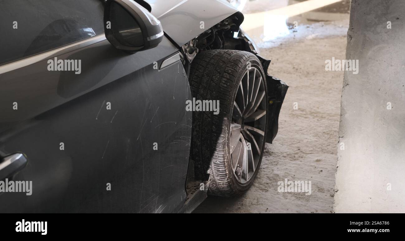 A damaged black car with a crumpled right front wing resulting from a ...