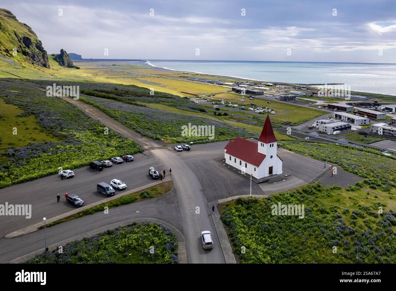 A picturesque aerail view of icelandic church in Vik near reynisfjara ...