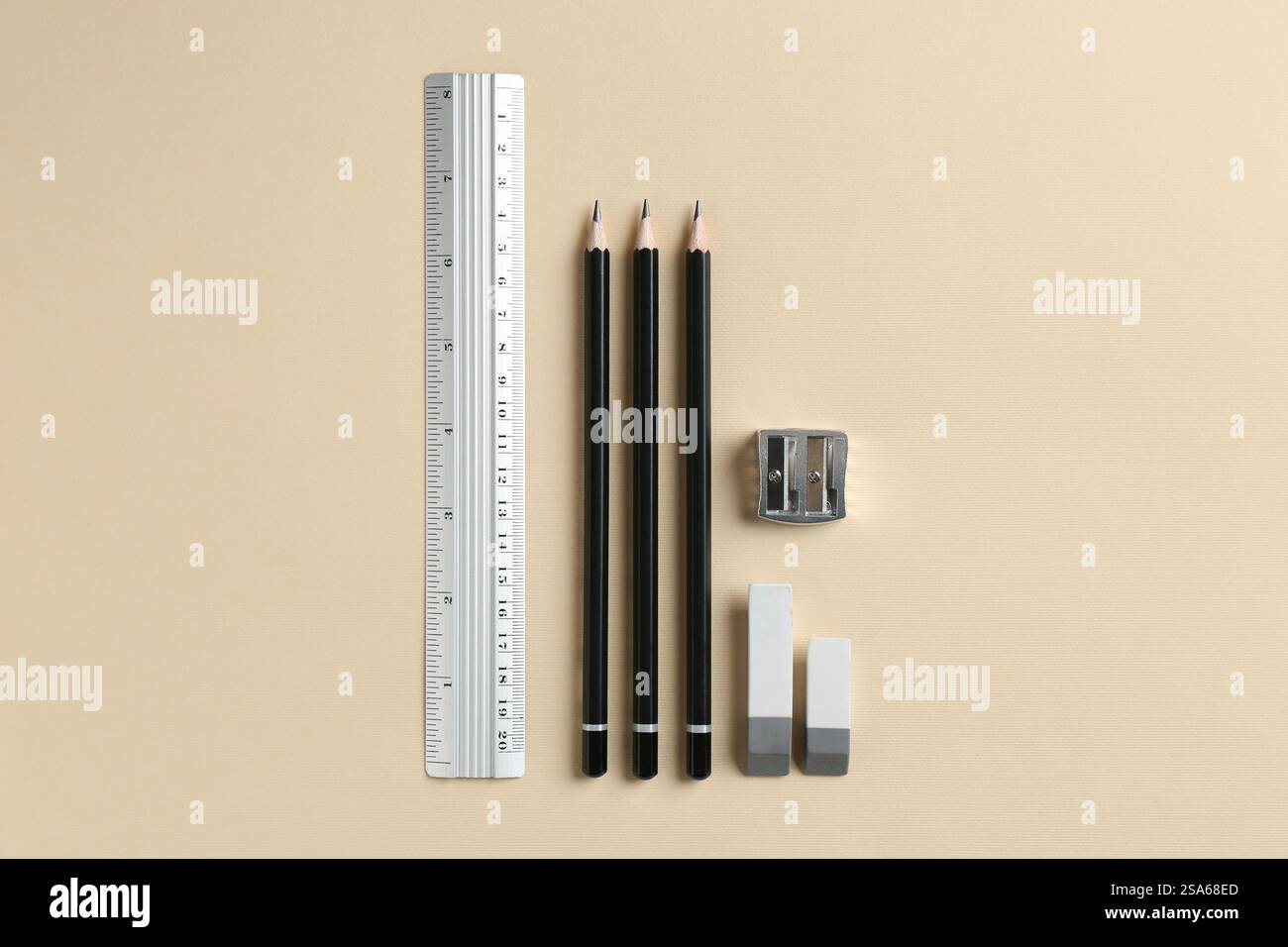 Flat lay composition with ruler and other stationery on beige ...