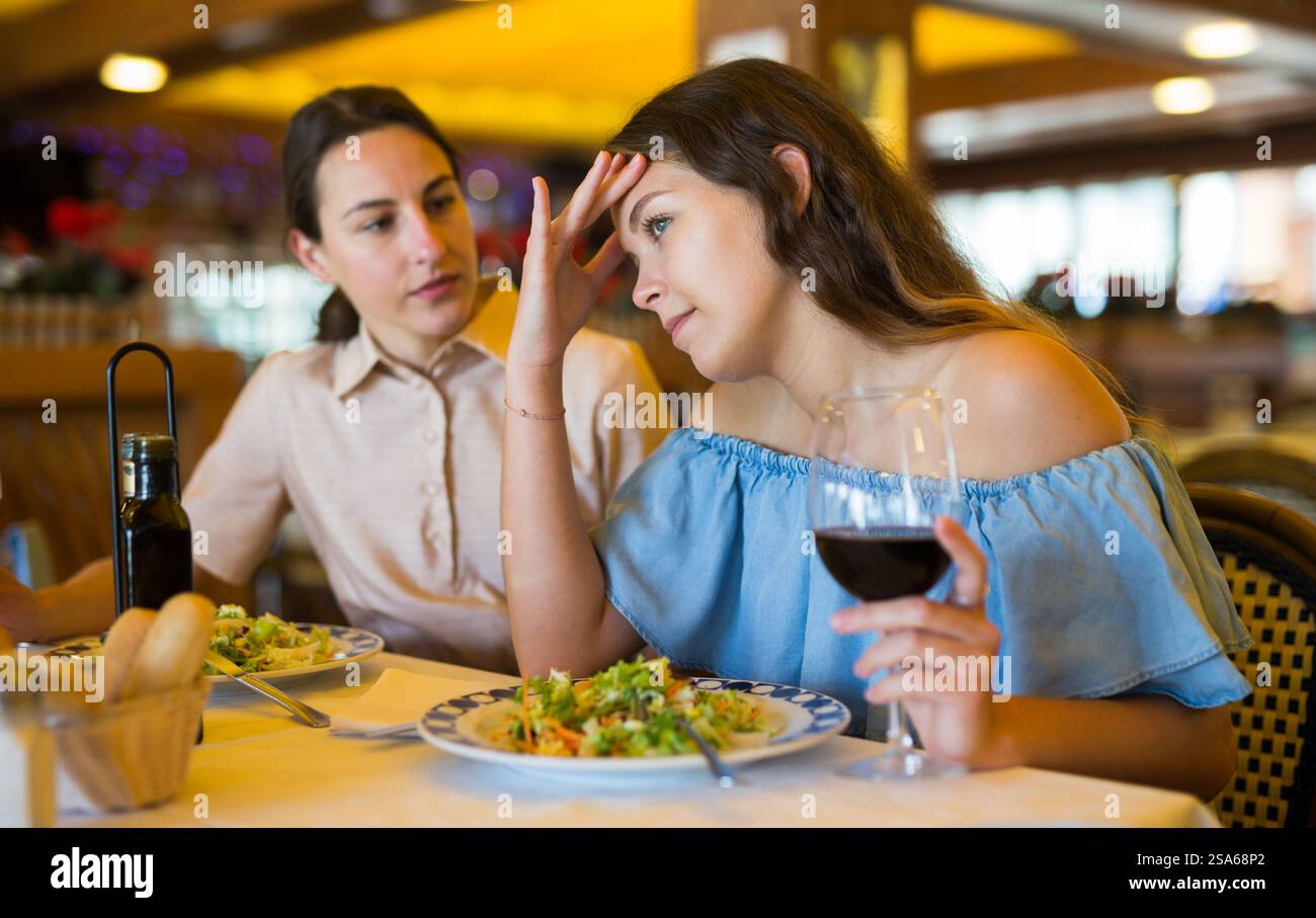 Two best friends have fun talking at a table in restaurant Stock Photo ...
