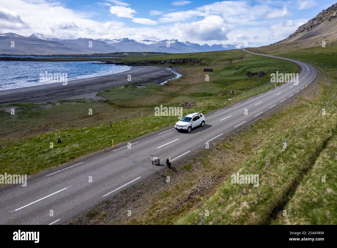 Scenic aerial view of coastal road with car in a picturesque landscape ...