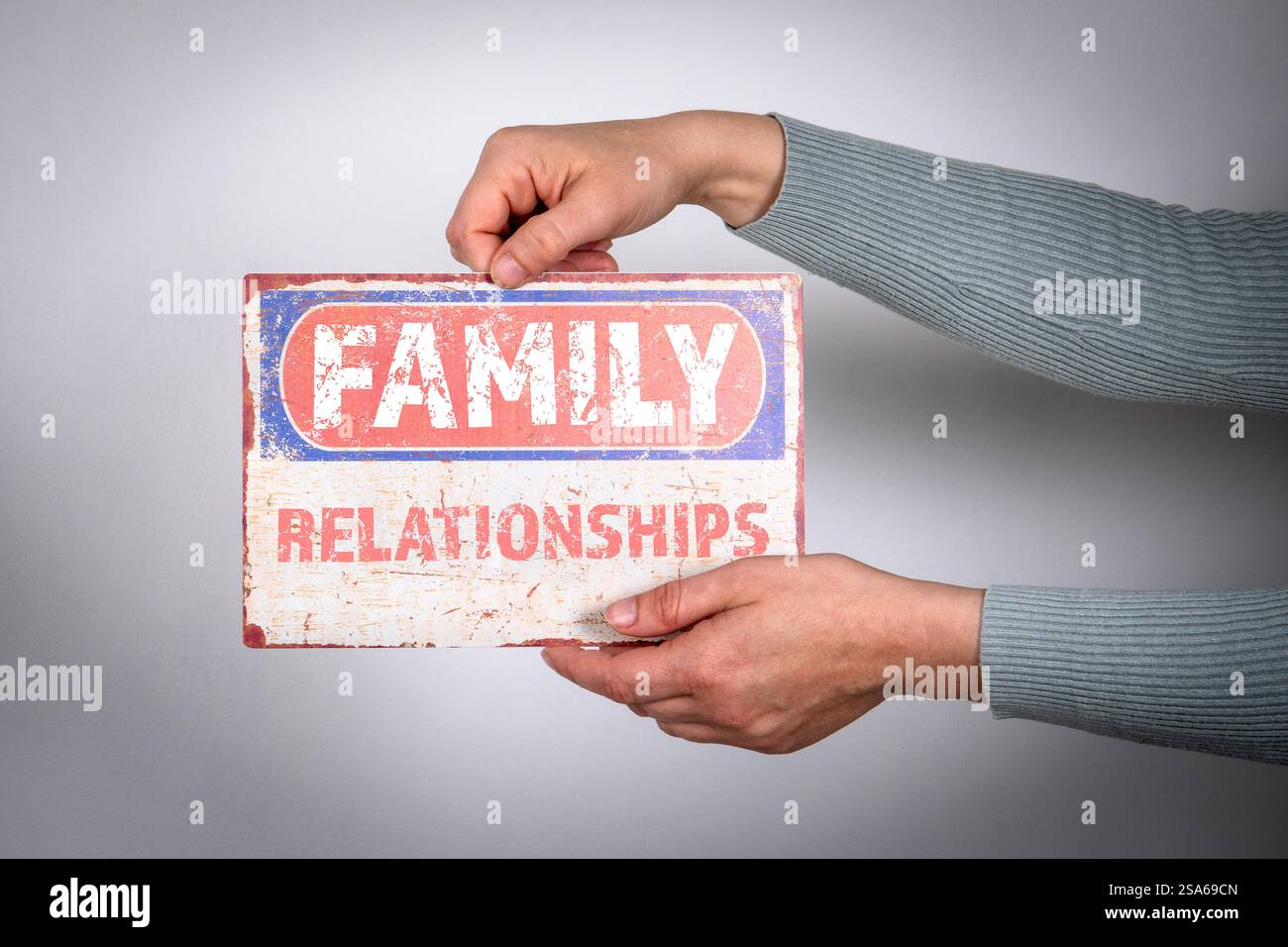FAMILY and RELATIONSHIPS. Sign with text in woman's hands Stock Photo ...