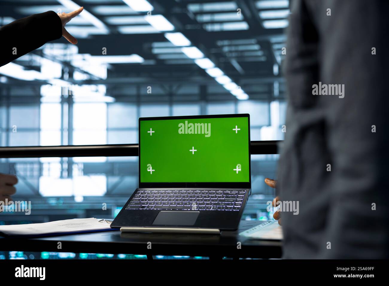 System Administrators In Data Center Using Green Screen Mockup Notebook
