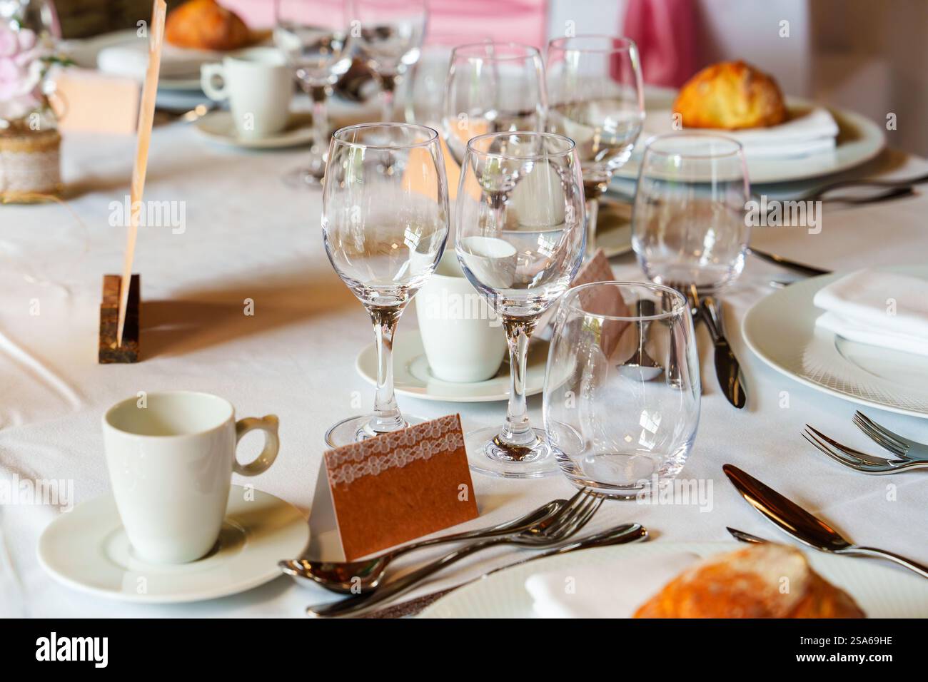 Elegant table setting with wine glasses, bread roll and name tag Stock ...