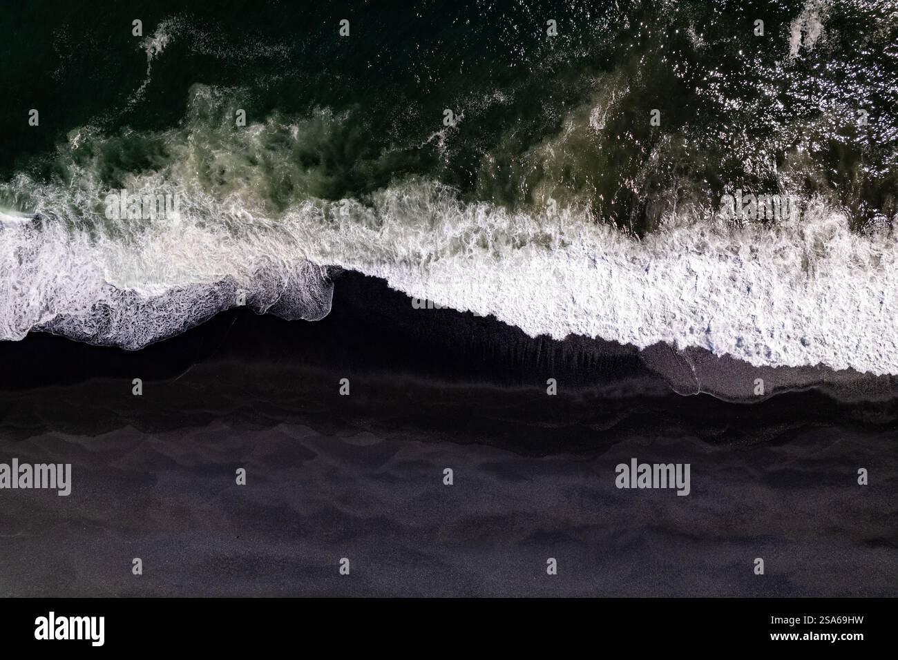 Aerial drone view of epic ocean waves crashing on the shoreline black ...