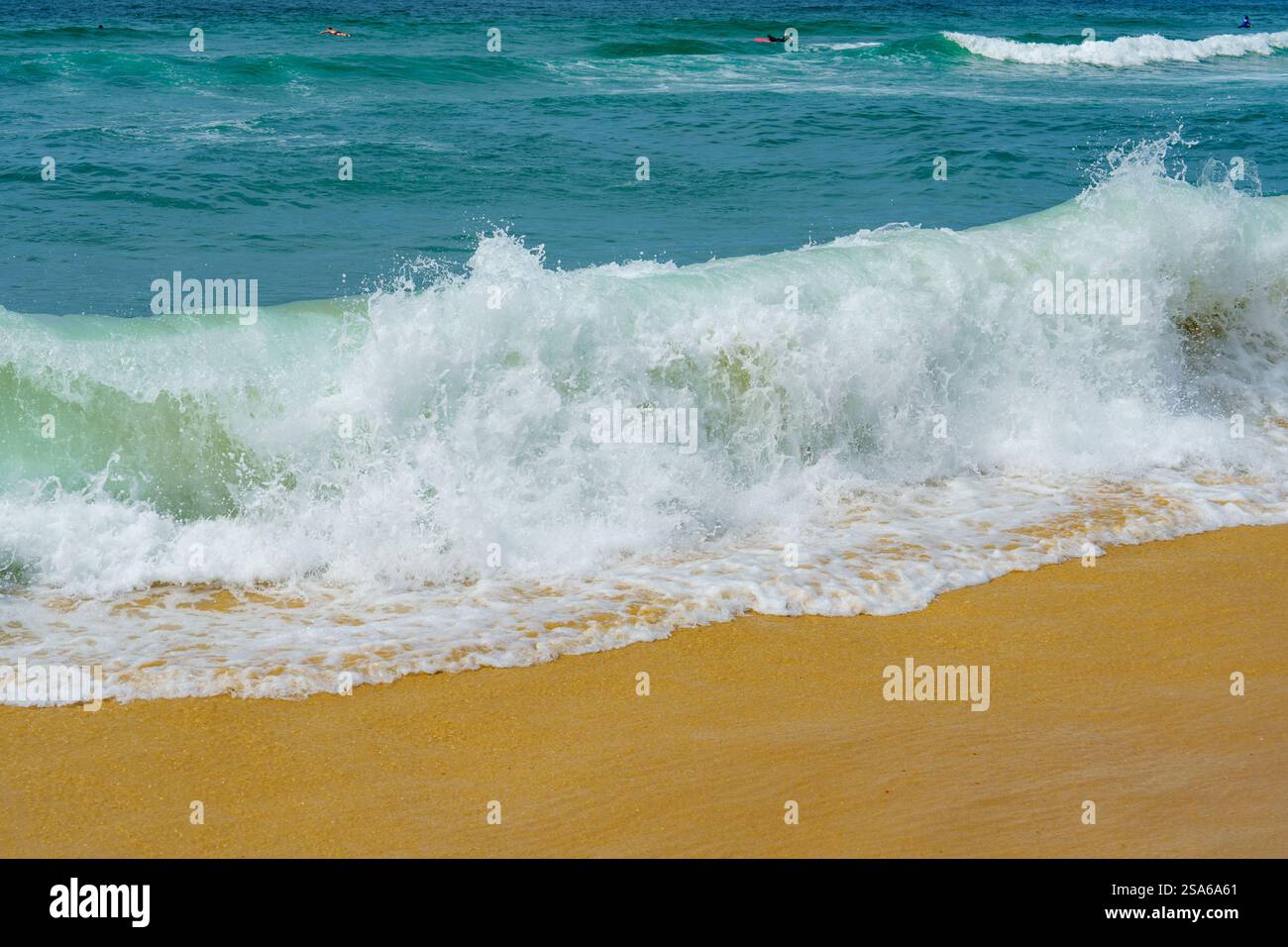 Dynamic Ocean Wave Breaks Forcefully on Sandy Beach Under Clear Blue ...