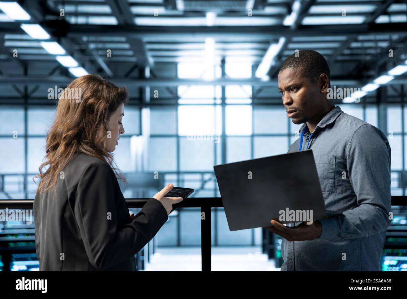 Computer Scientists In Data Center Using Laptop And Tablet Executing