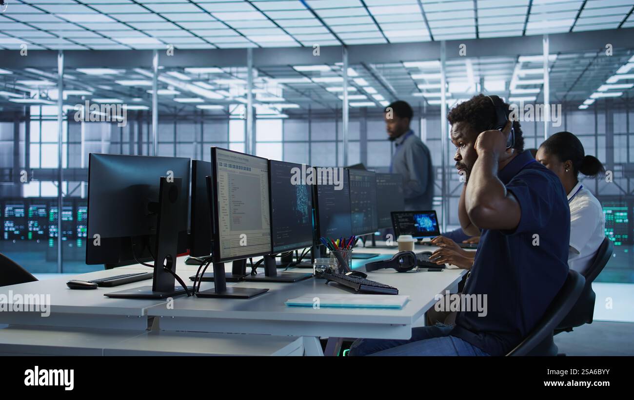 Technician entering data center, tuning music on and starting work on AI predictive maintenance ...