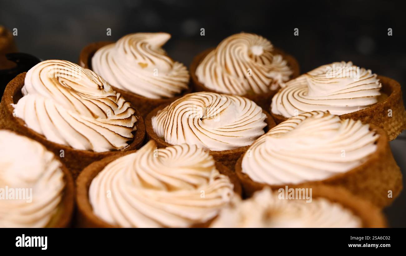 Creamy white tart with golden toasted top in shortcrust pastry on white ...