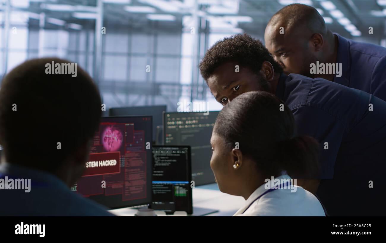 Team of engineers in server hub trying to protect gear from hacker ...