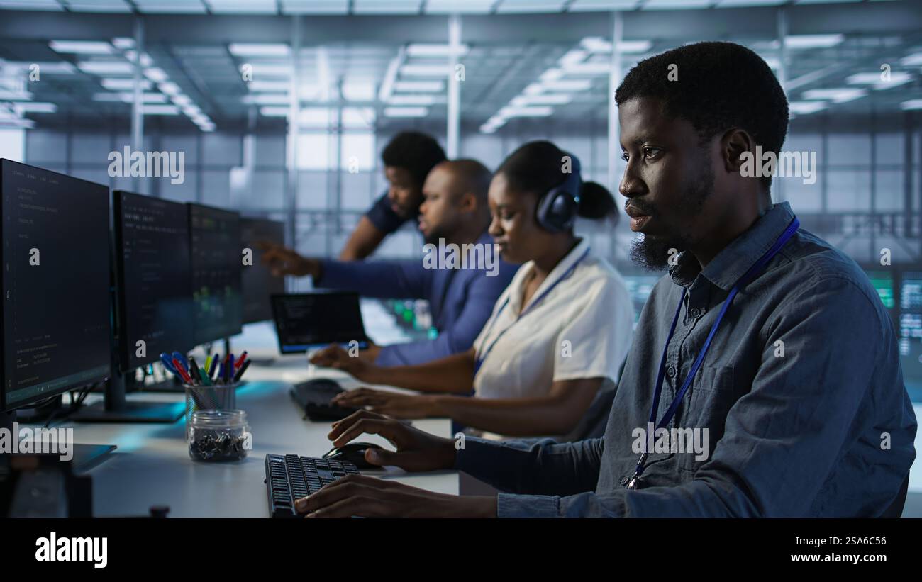 Software developers in data center implementing AI predictive maintenance systems. Focus on man ...