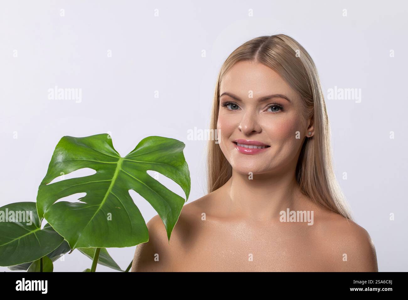 A beautifully elegant portrait featuring a Monstera plant alongside ...