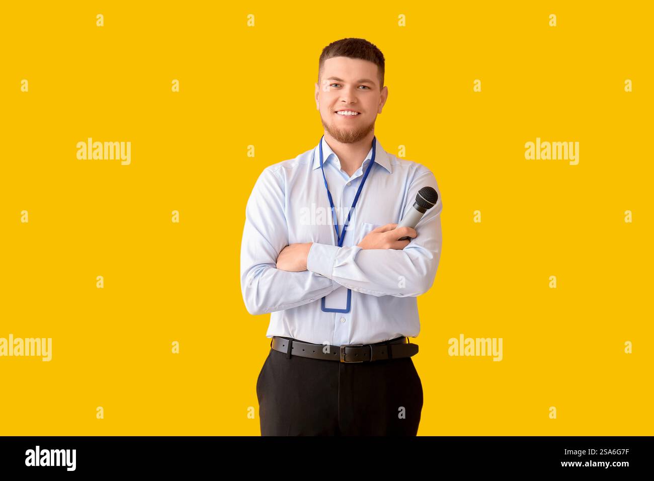 Male reporter with microphone and name tag on yellow background Stock ...