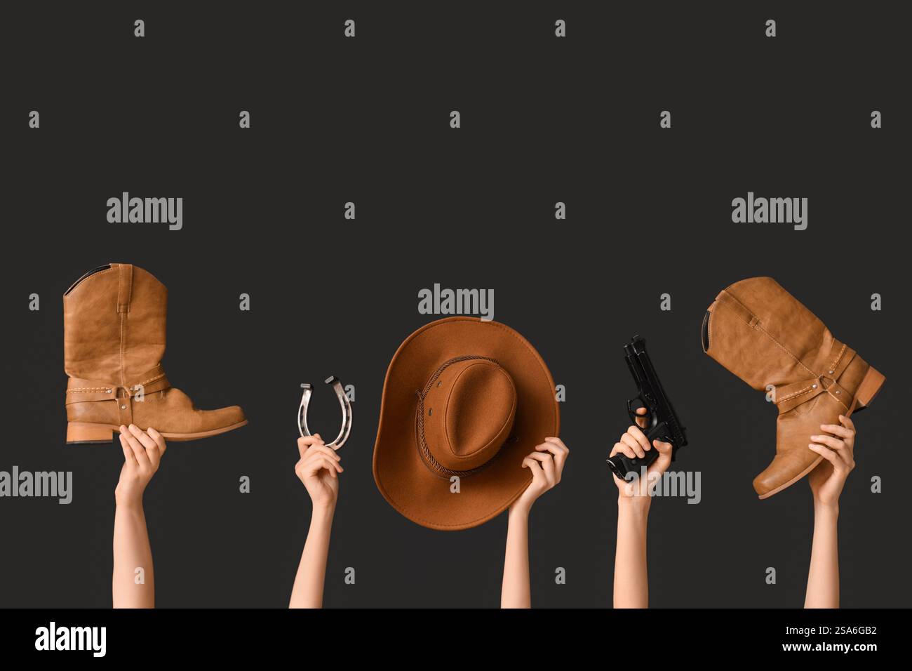 Female hands with cowboy accessories and gun on dark background Stock ...