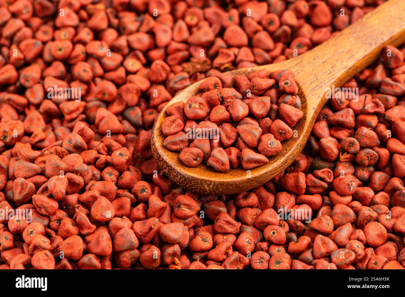 Organic, dried, raw, red Bixa Orellana seeds - Achiote Stock Photo - Alamy