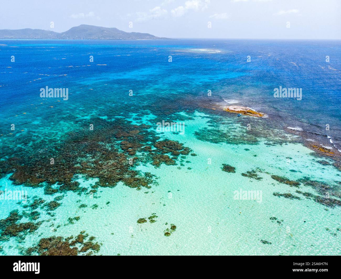 Aerial drone view of tiny tropical island and turquoise Caribbean sea ...