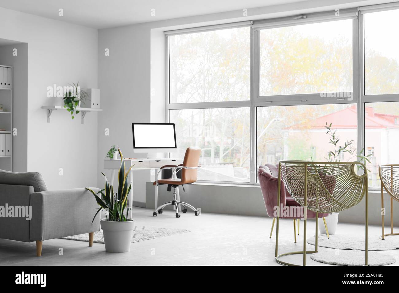 Interior of clothing store office with workplace and armchairs Stock ...