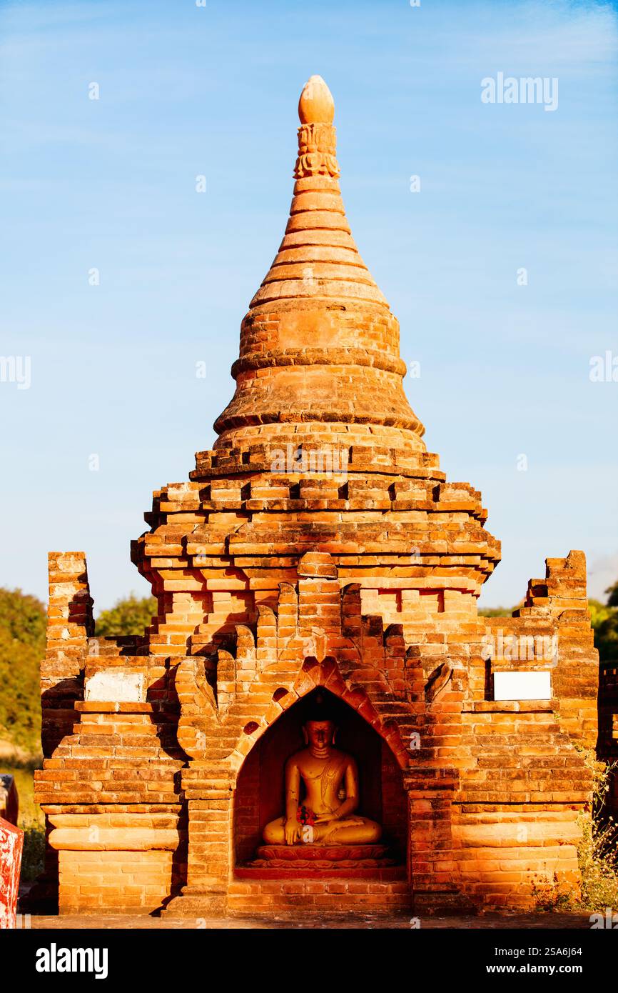 Ancient Stupa with Buddha statue inside in Bagan Myanmar Stock Photo ...
