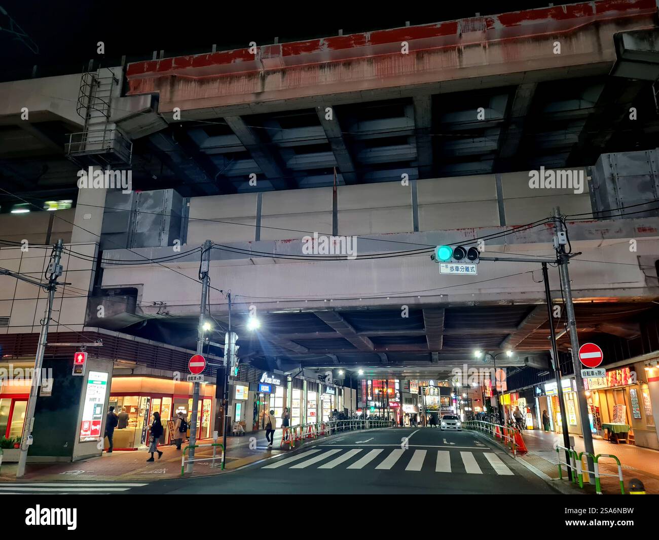 Night scene in Akabane in Tokyo, Japan with a bridge, people and a ...