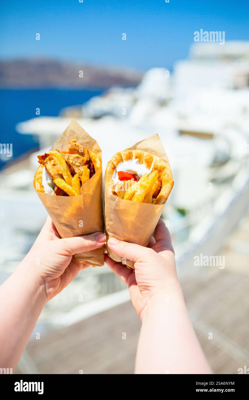 Greek gyros wrapped in pita bread photographed against traditional ...