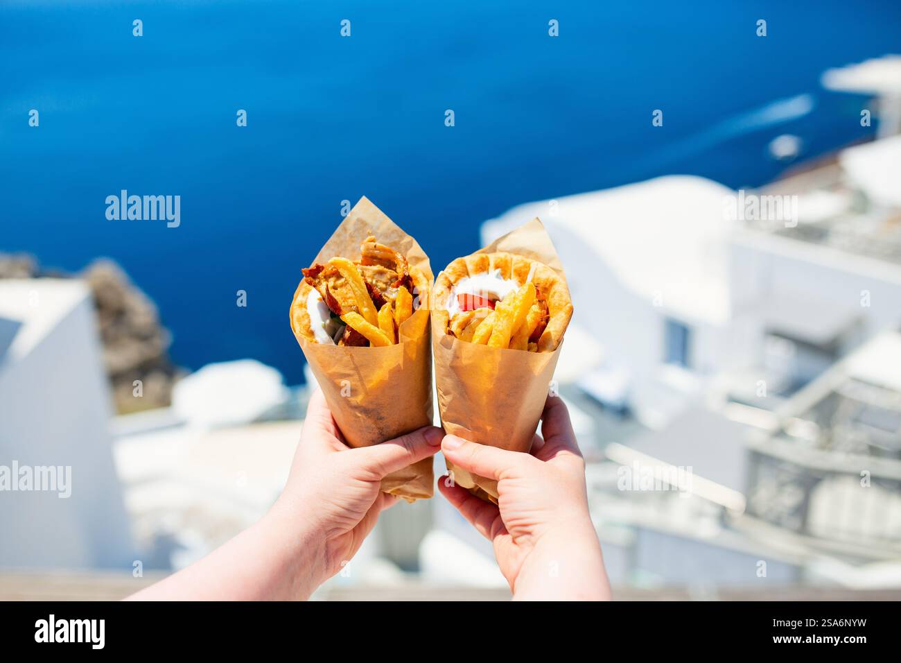 Greek gyros wrapped in pita bread photographed against traditional ...