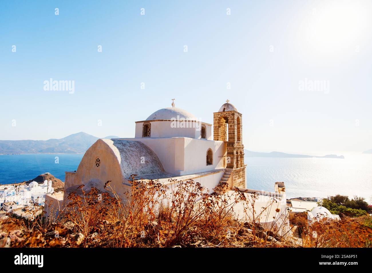 Breathtaking sunset view over traditional whitewashed Greek Orthodox ...