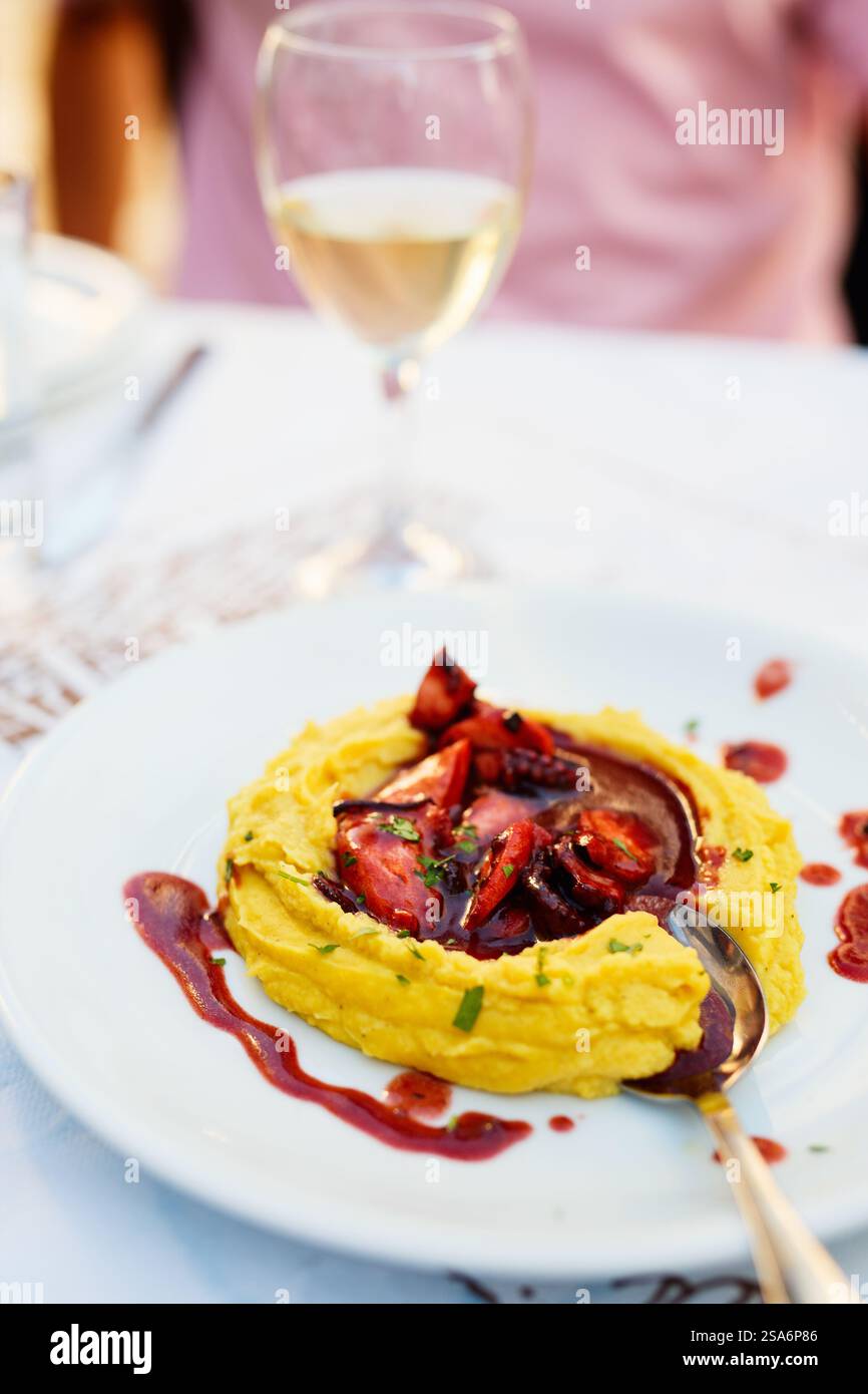 Authentic greek fava dish served with octopus and white wine for lunch ...