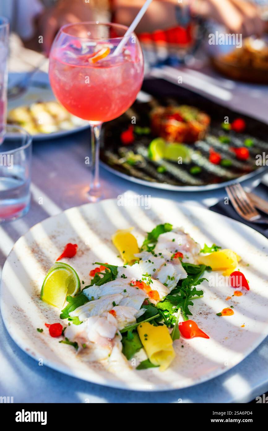 Close up of gourmet fresh fish carpaccio served for lunch in outdoor ...