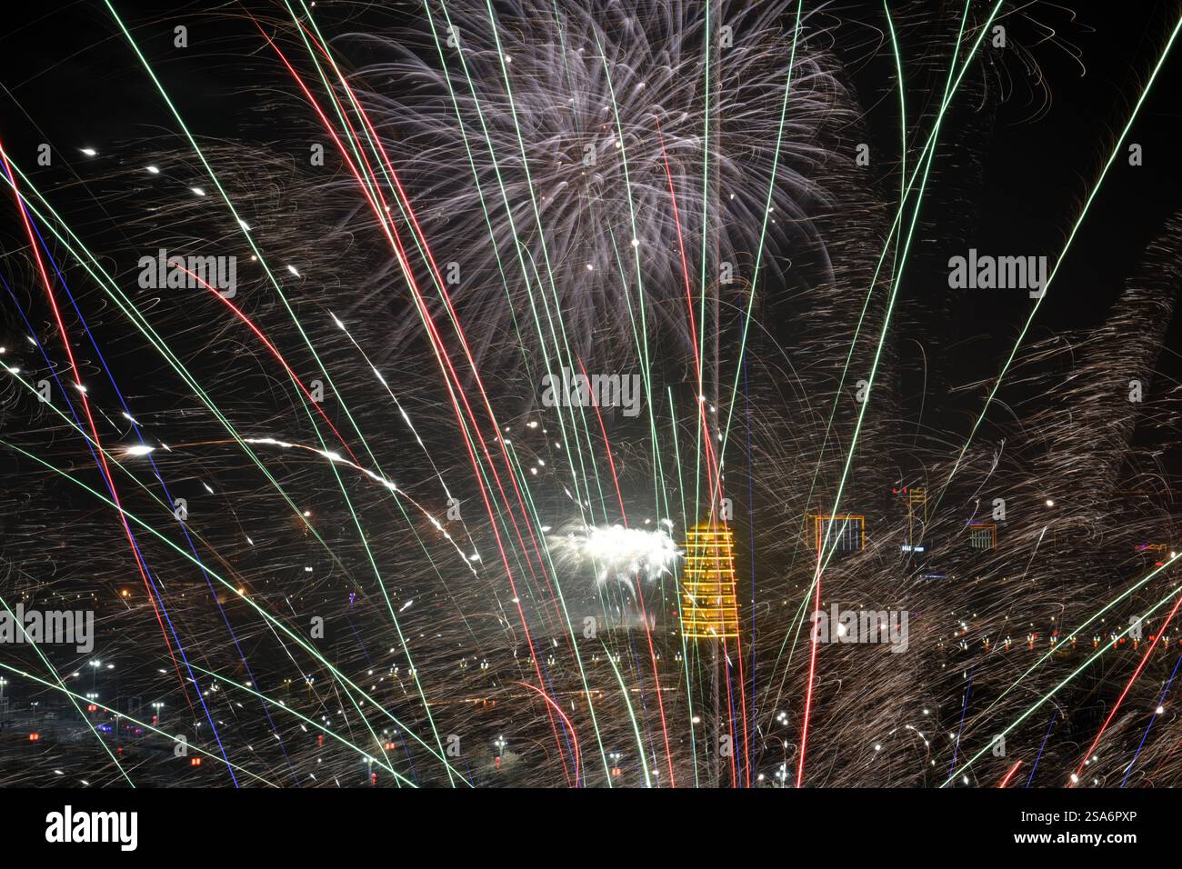 KORLA, CHINA - JANUARY 28, 2025 - People hold a fireworks and light ...