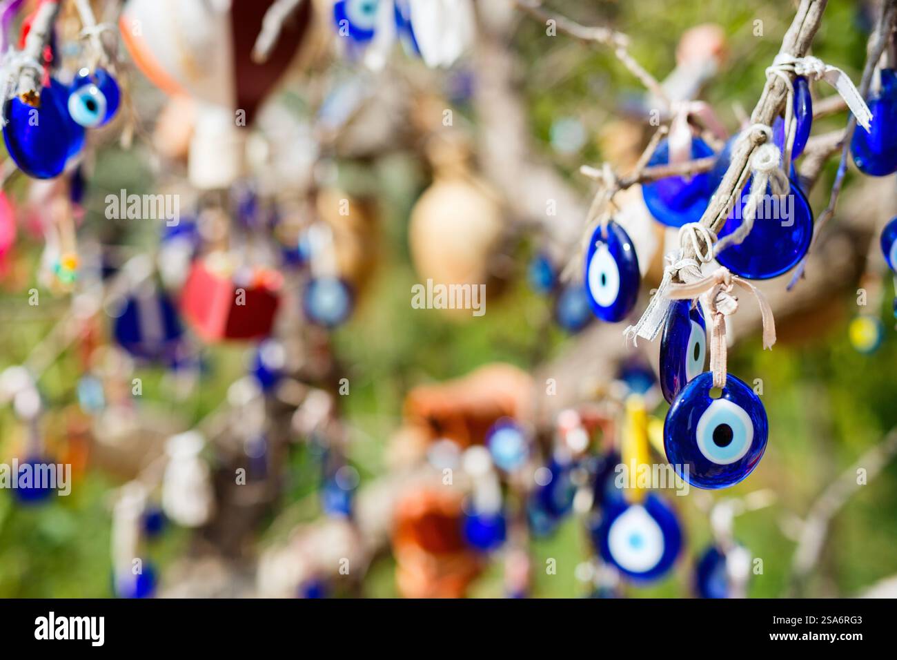 Evil eye charms hang from tree in Cappadocia Turkey for good luck Stock ...