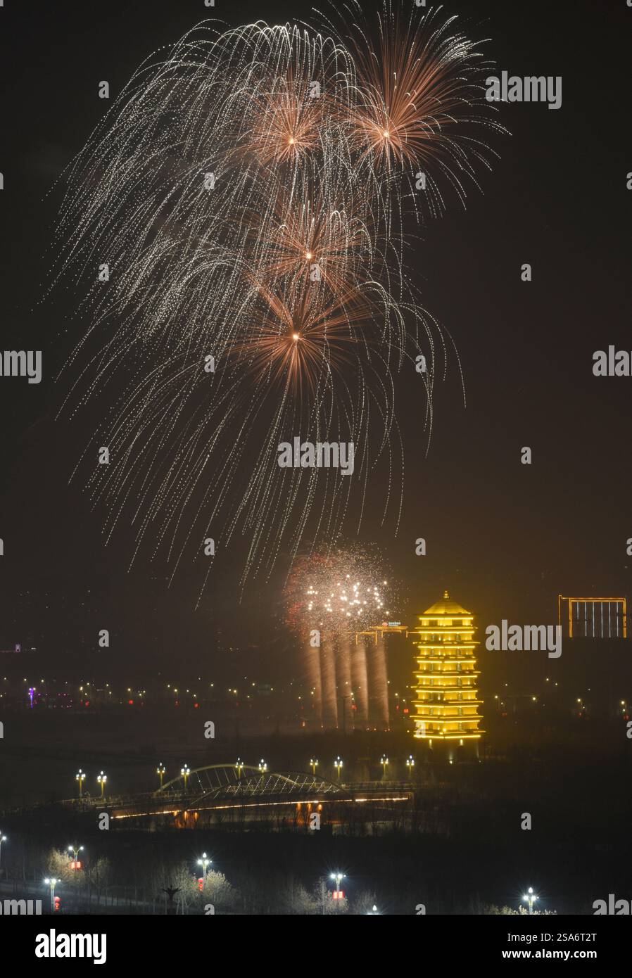 KORLA, CHINA - JANUARY 28, 2025 - People hold a fireworks and light ...
