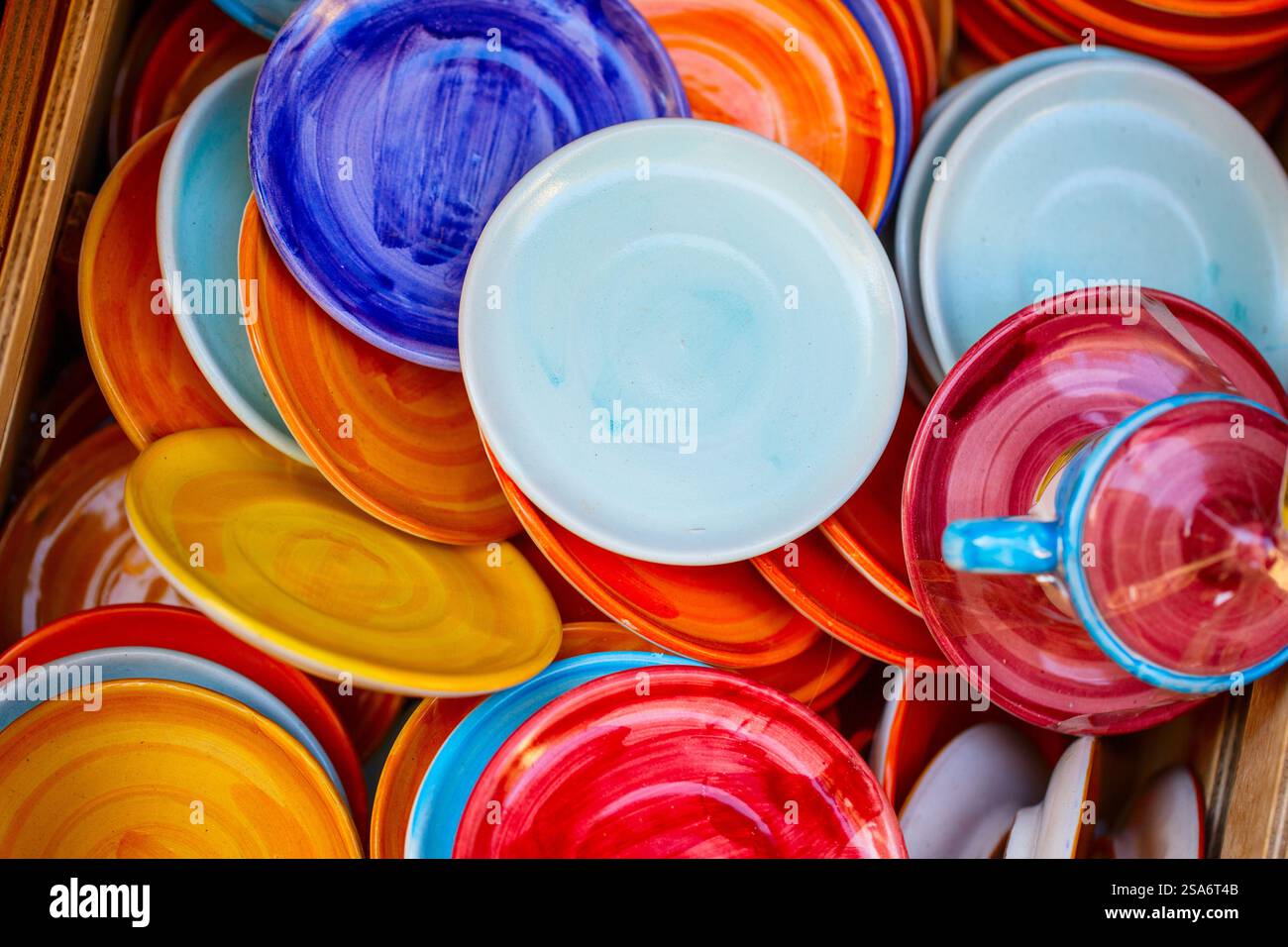 Colorful small dishes in ceramic factory in Italy Stock Photo - Alamy