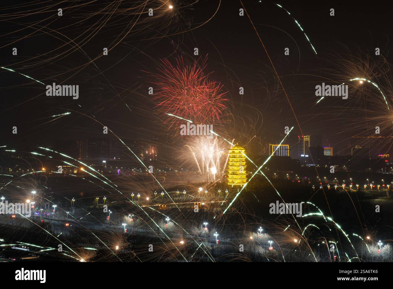 KORLA, CHINA - JANUARY 28, 2025 - People hold a fireworks and light ...