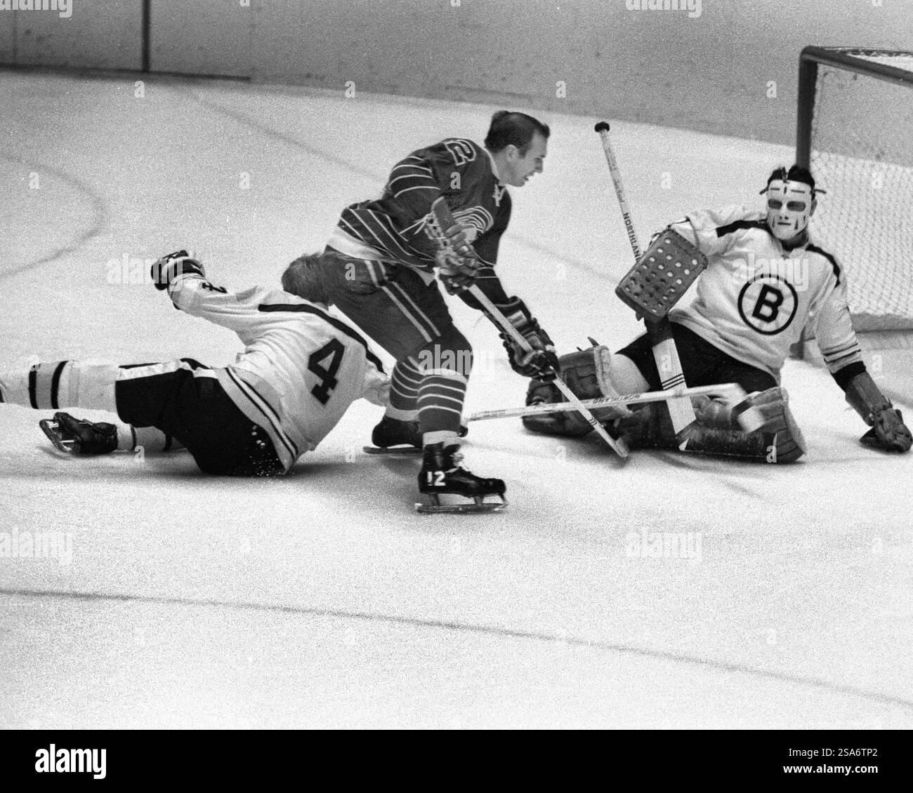 California Seals Gary Jarrett (12) tries to score against Boston Bruins ...