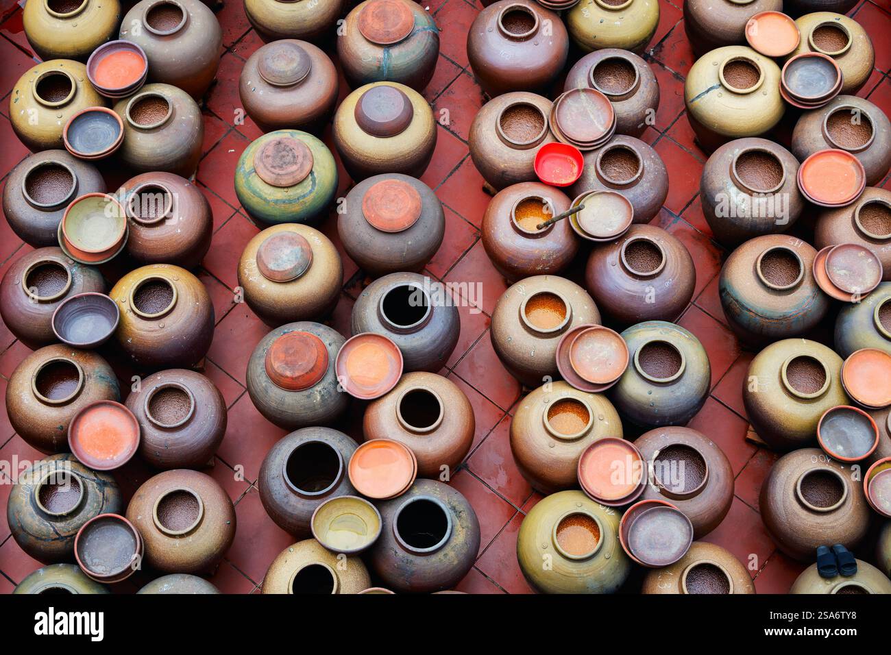 Ceramics pots where soya beans are fermented to produce soy sauce in ...