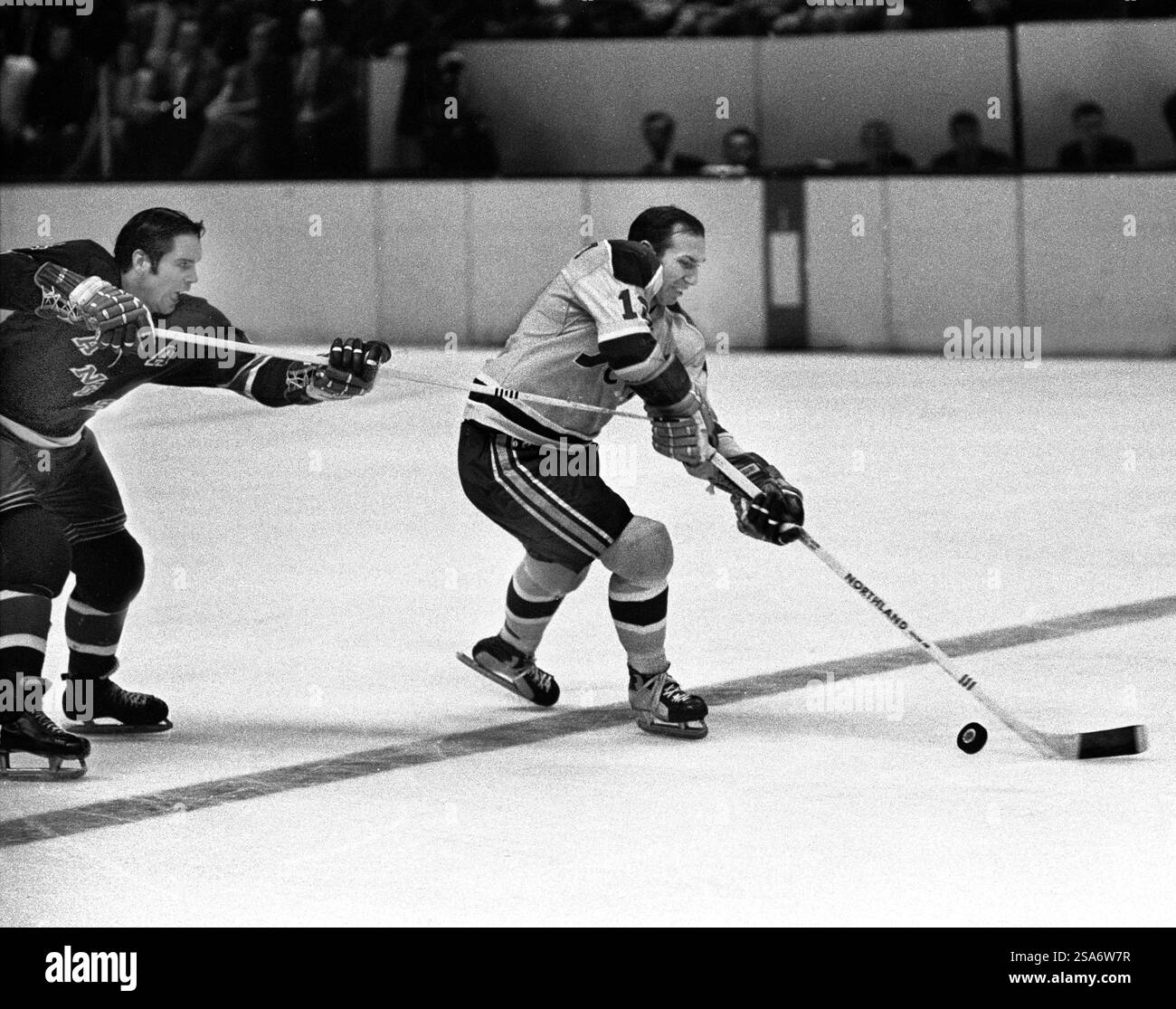California Golden Seals Gary Jarrett (12) gets hooked by New York ...