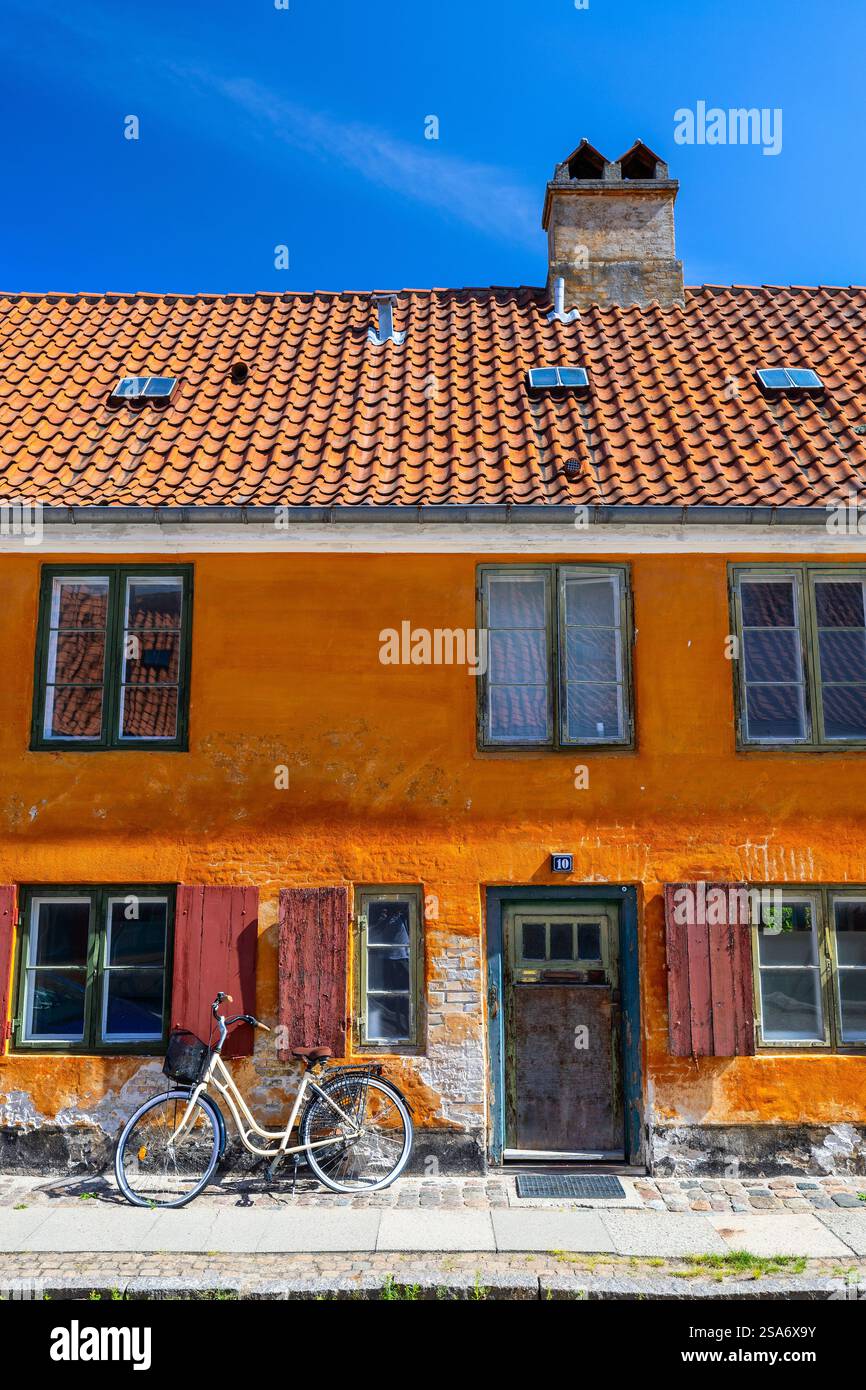 Traditional colorful yellow house in Copenhagen historic district of ...