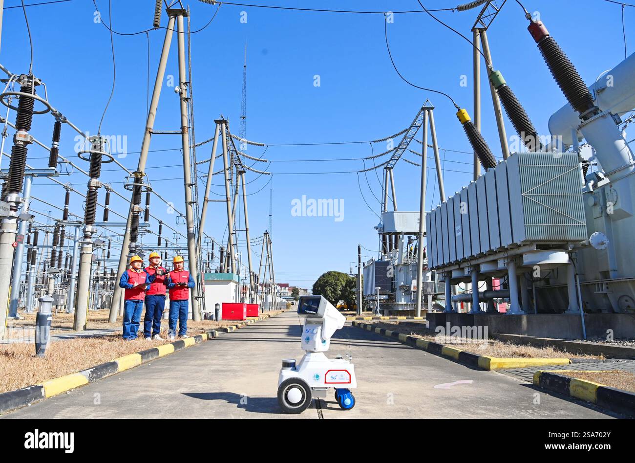 A 5G intelligent inspection robot and staff use a drone to conduct a ...