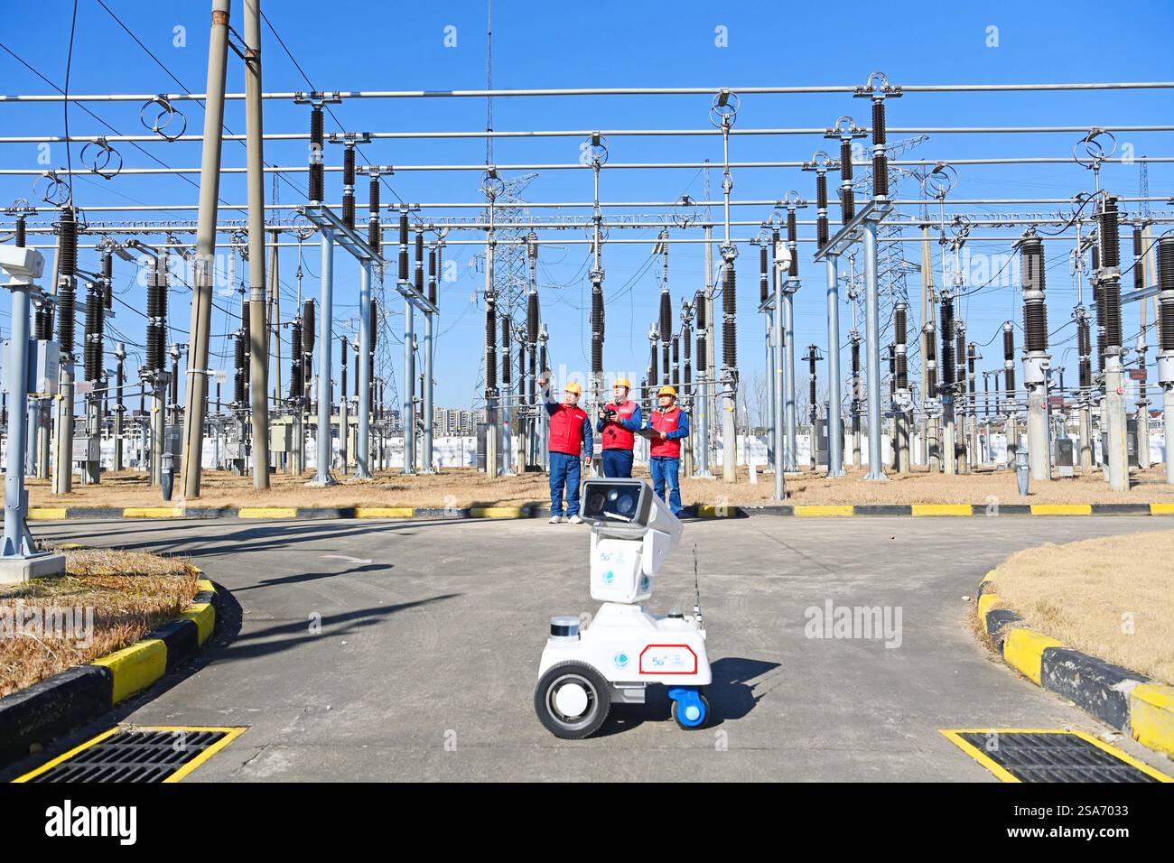 A 5G intelligent inspection robot and staff use a drone to conduct a ...