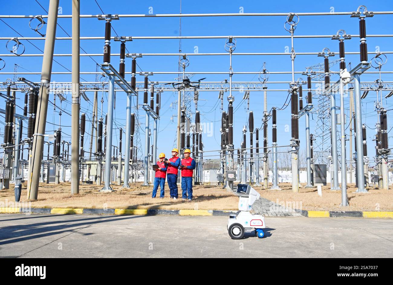 A 5G intelligent inspection robot and staff use a drone to conduct a ...